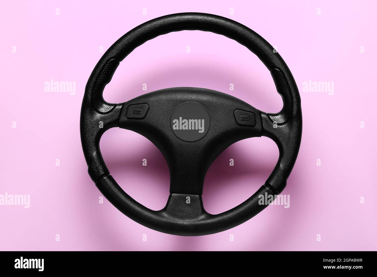 Black modern steering wheel on color background Stock Photo - Alamy
