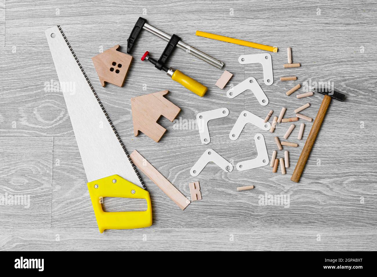 Set of tools for furniture assembling and wooden houses on grey wooden ...