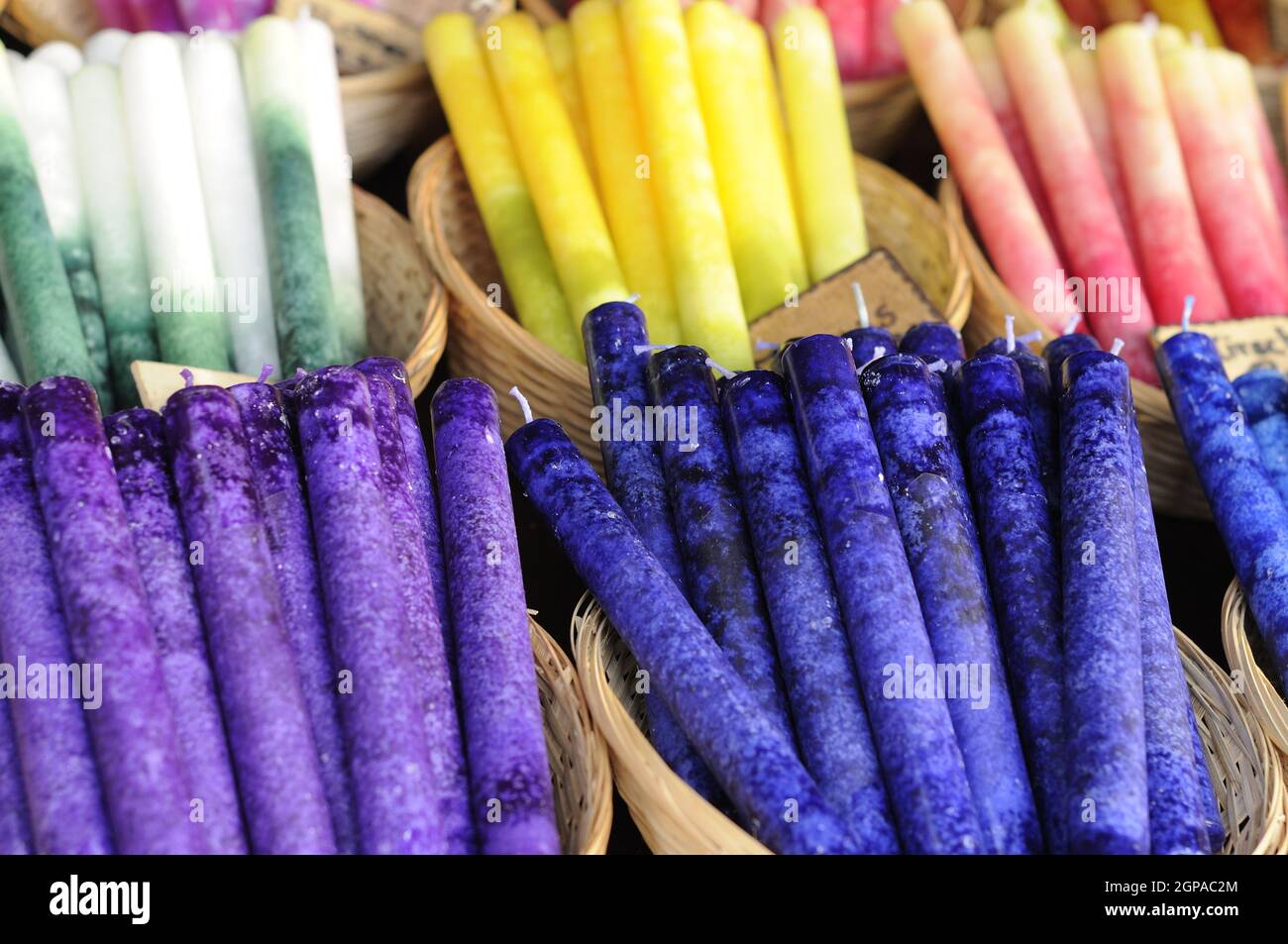 detail of traditional hand made colorful candles in stand at medieval ...