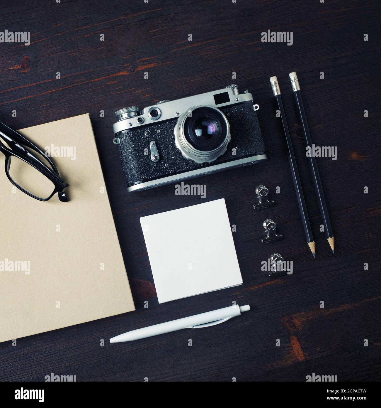 Vintage still life with retro photo camera and stationery on wooden ...