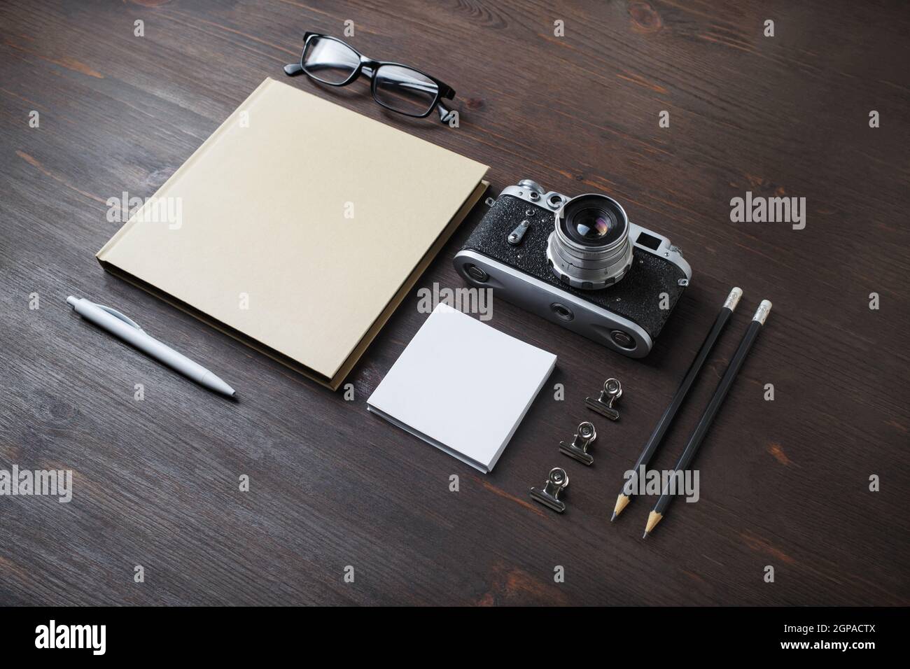 Retro photo camera and blank stationery set on wooden background Stock ...