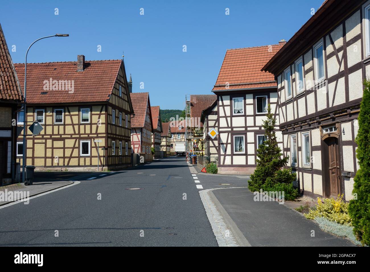 Village with half-timbered houses, with a truck in the narrow street in ...