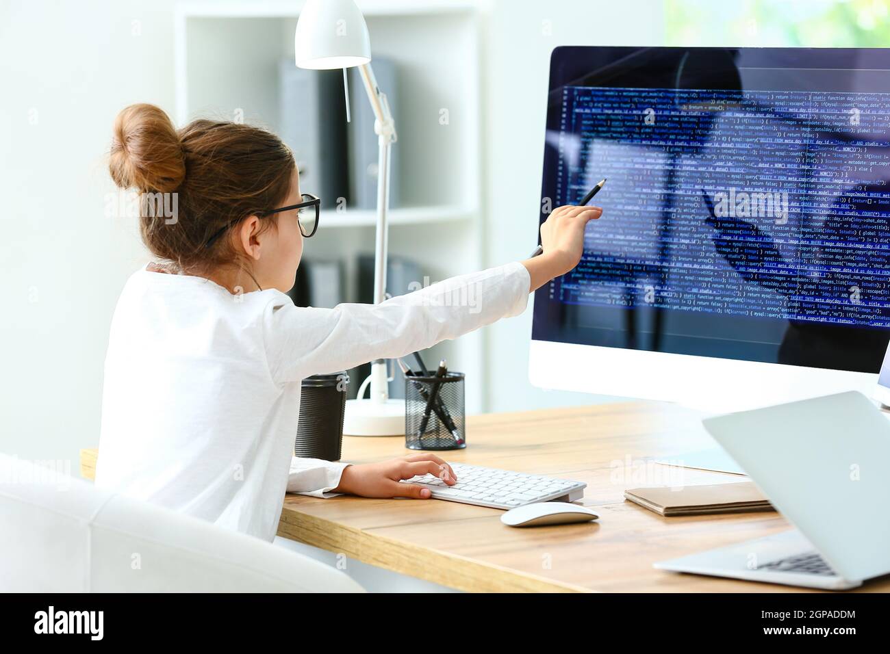 Little programmer using computer in office Stock Photo - Alamy