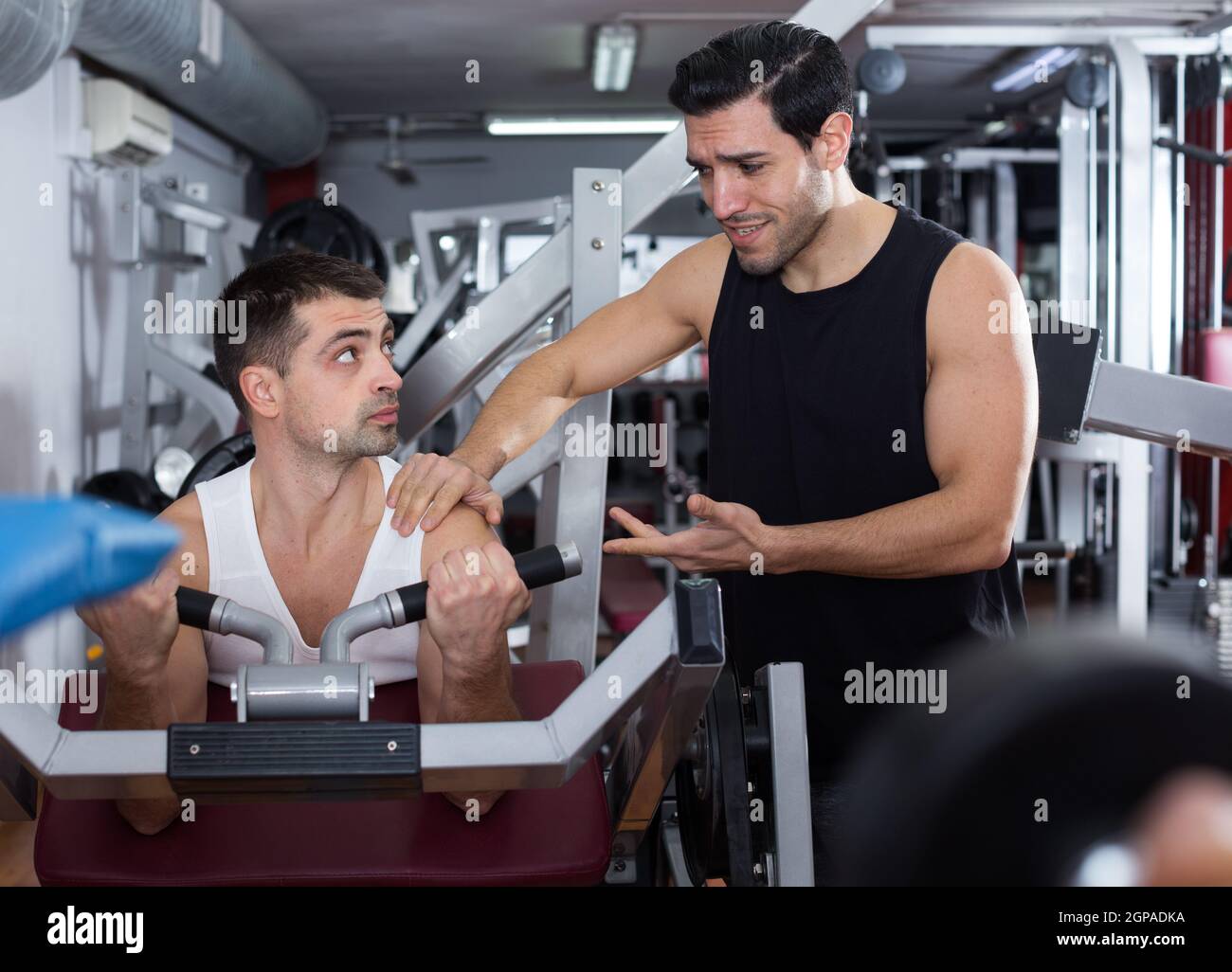 Man during training with instructor in gym Stock Photo - Alamy