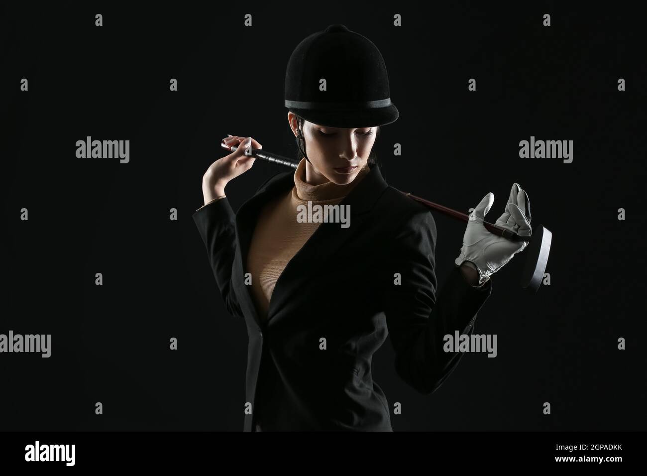 Beautiful female polo player on dark background Stock Photo - Alamy