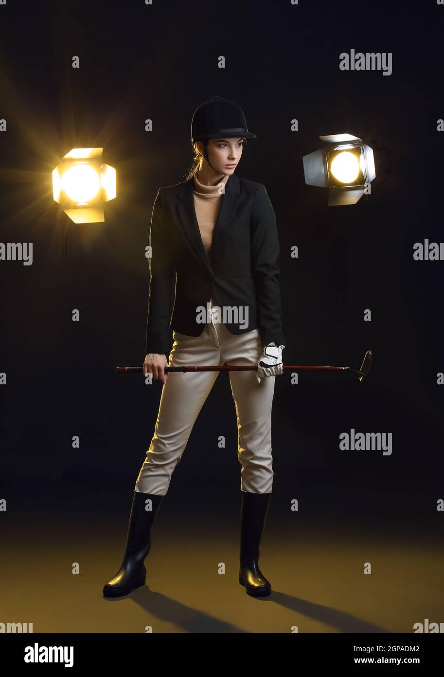 Beautiful female polo player on dark background Stock Photo - Alamy