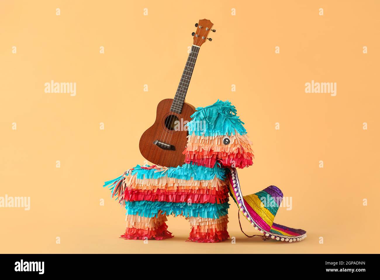 Mexican pinata in shape of horse, sombrero hat and guitar on color ...