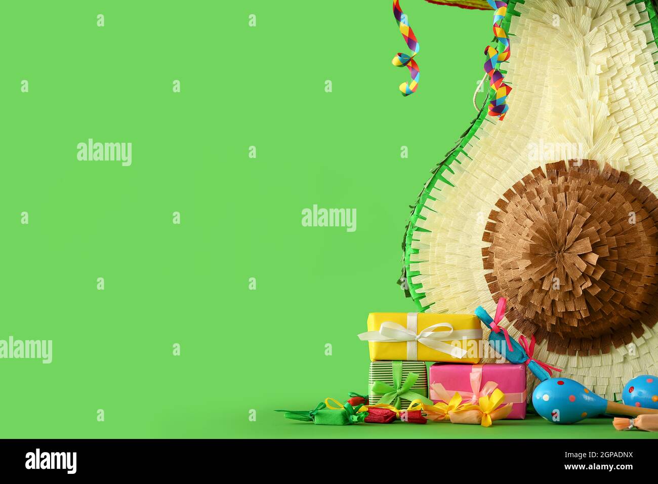 Mexican pinata with maracas and gifts on color background Stock Photo ...
