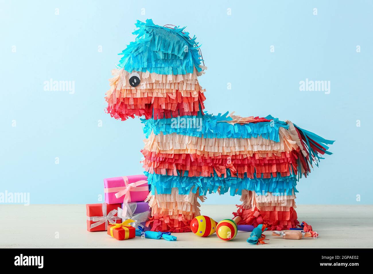Mexican pinata with gifts and maracas on table Stock Photo - Alamy