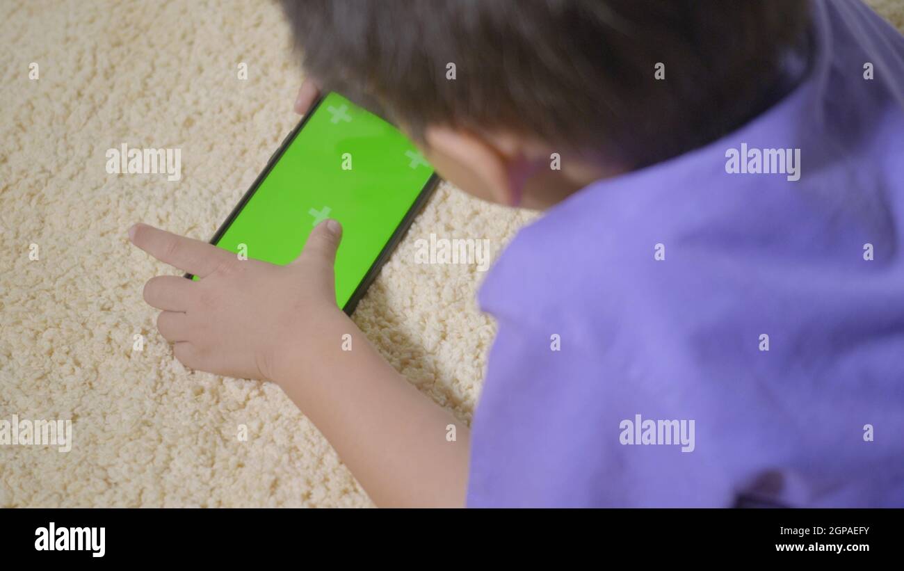 Asian kid boy preschool with gadget playing video games digital on ...