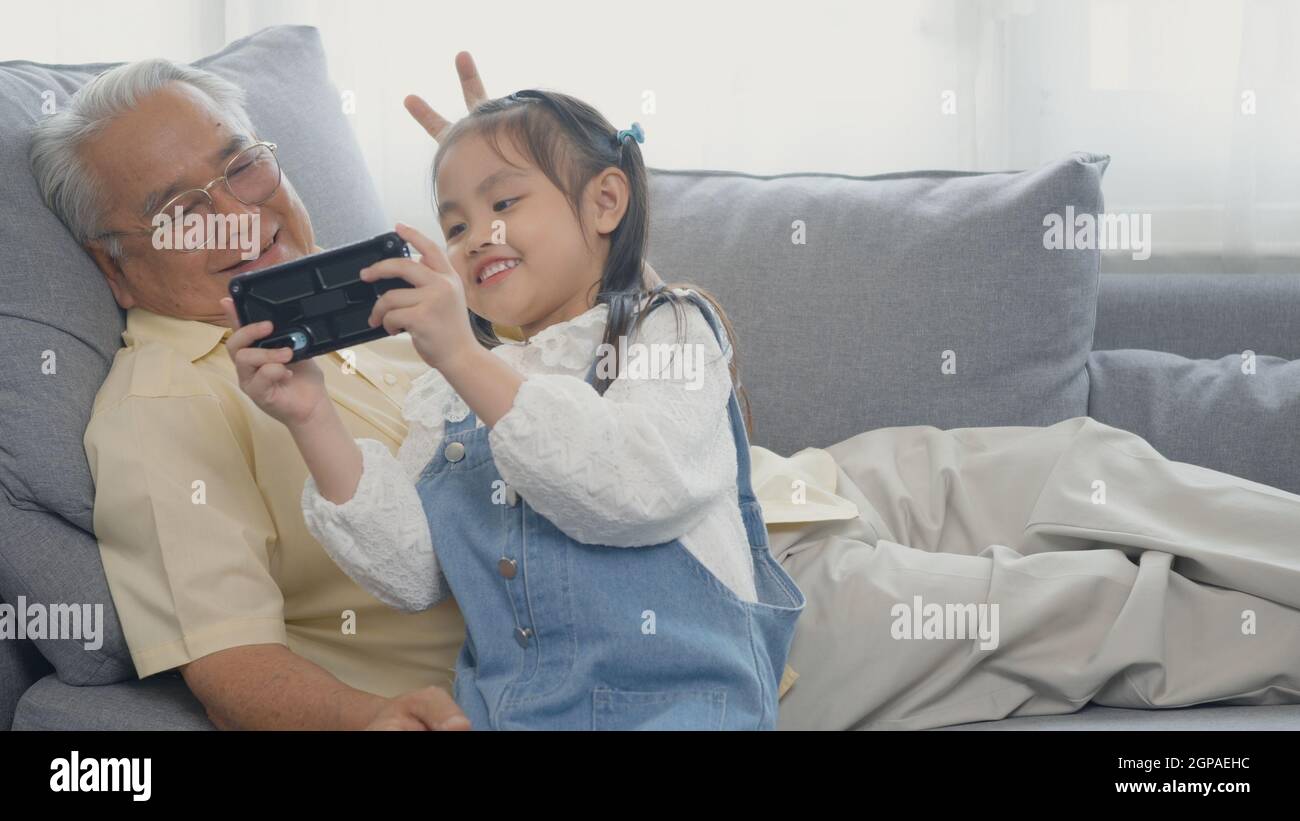 Happy senior grandfather with grandson taking photo by smartphone, old ...