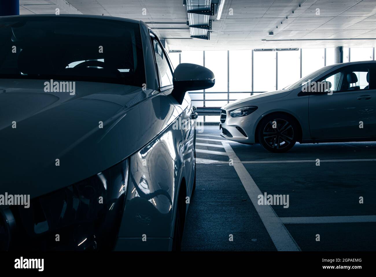 Underground parking. Cars parked in a garage with no people. Many cars ...