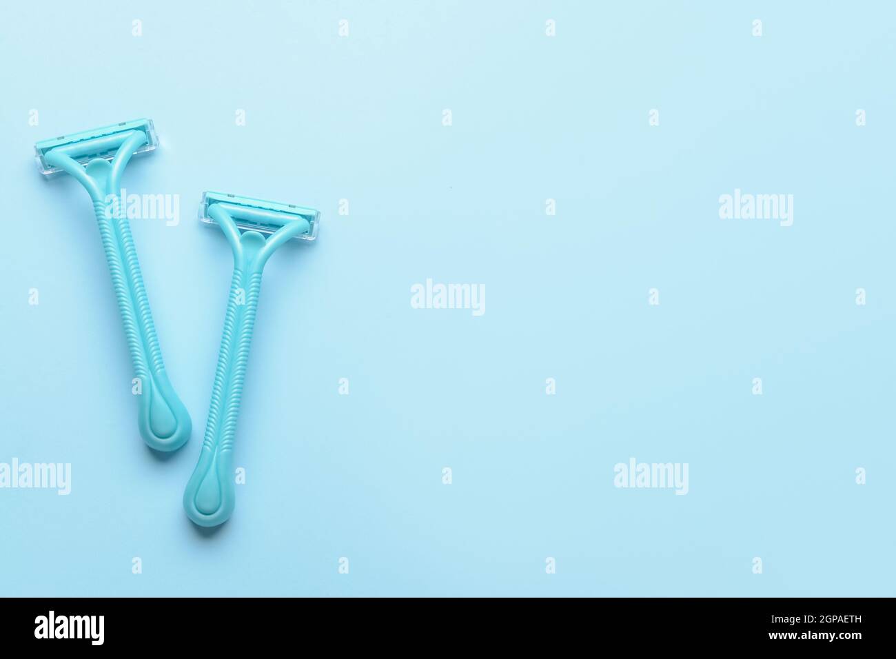 Safety razors on blue background Stock Photo - Alamy