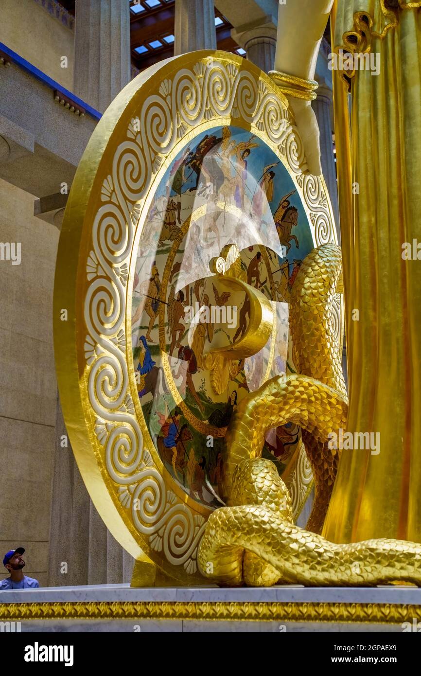 Visitor examines the shield of the Goddess Athena statue inside the ...