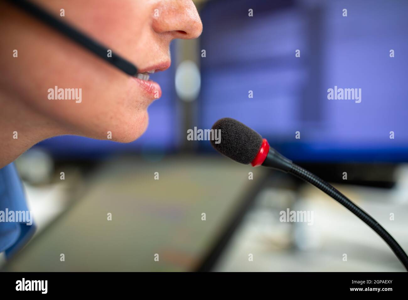 Call centre employee communicating over phone using an external ...