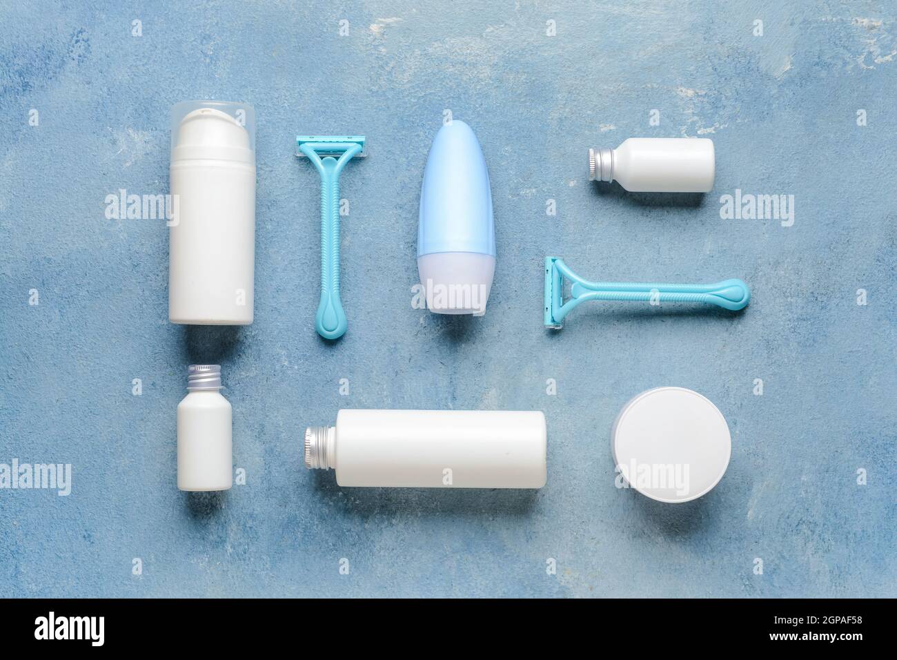 Composition with safety razors and cosmetic products on color ...