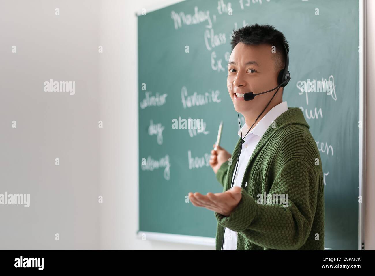 Asian teacher conducting English lesson online Stock Photo - Alamy