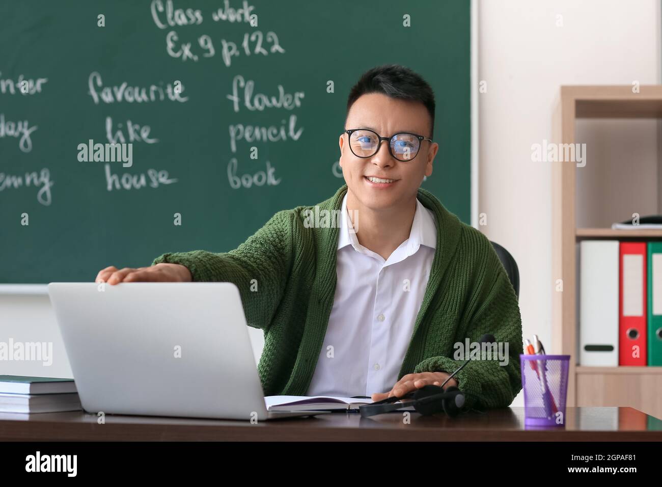 Asian teacher conducting English lesson online Stock Photo - Alamy