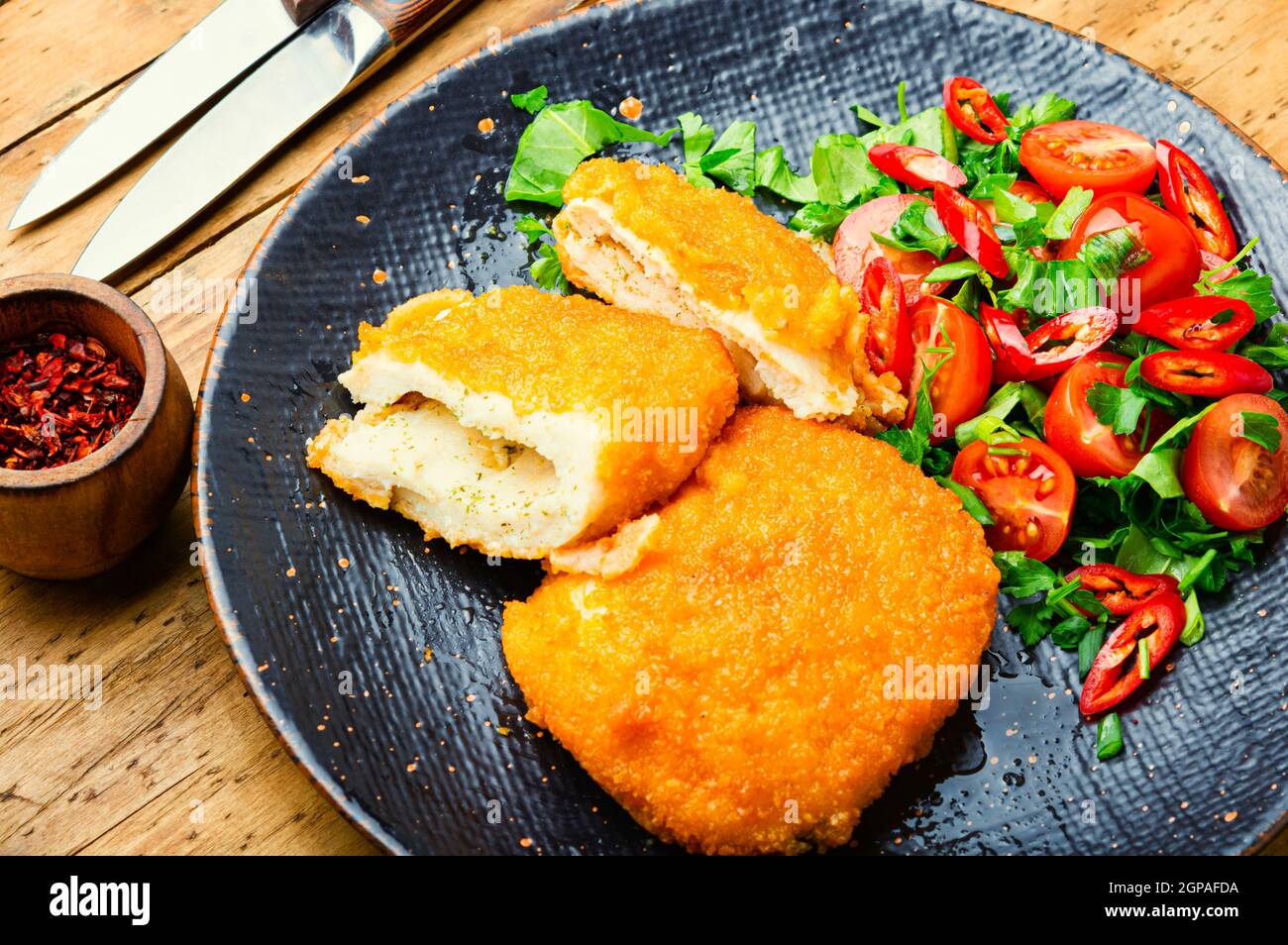 Chicken Kiev cutlet with fresh vegetable salad.Ukrainian food Stock ...