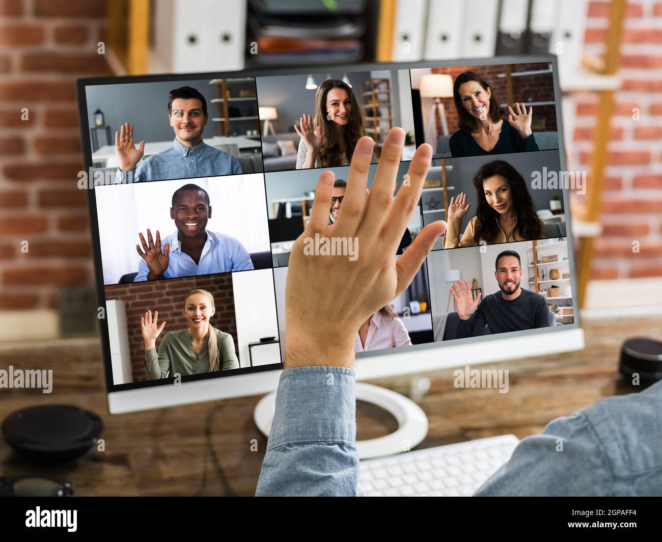 Video Conferencing Call Waving Hello With Hand Stock Photo - Alamy
