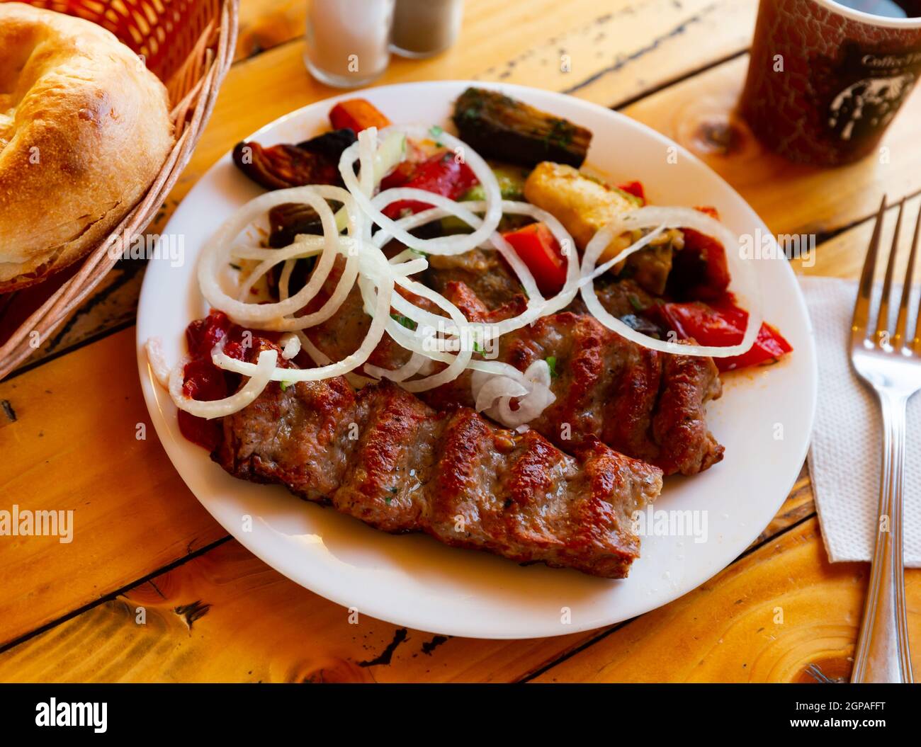 Grilled lula kebab - meat dish, with vegetable and onion. Popular ...