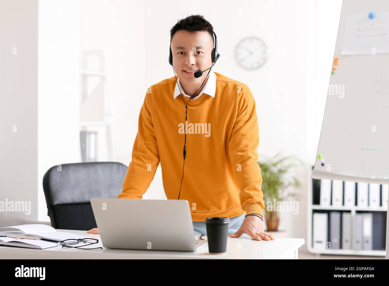 Asian teacher conducting lesson online in classroom Stock Photo - Alamy