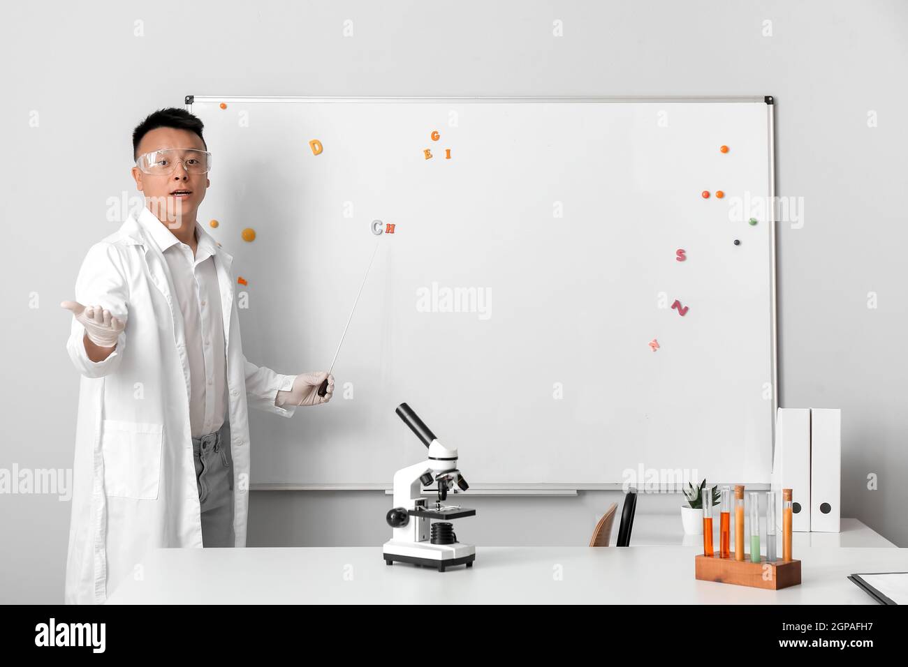 Asian teacher conducting chemistry lesson Stock Photo - Alamy