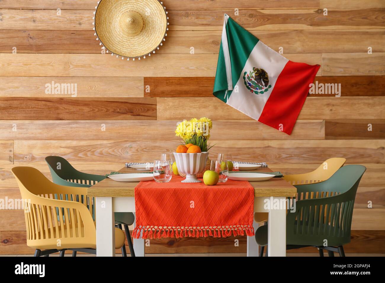 Mexican flag and dining table near wooden wall Stock Photo - Alamy