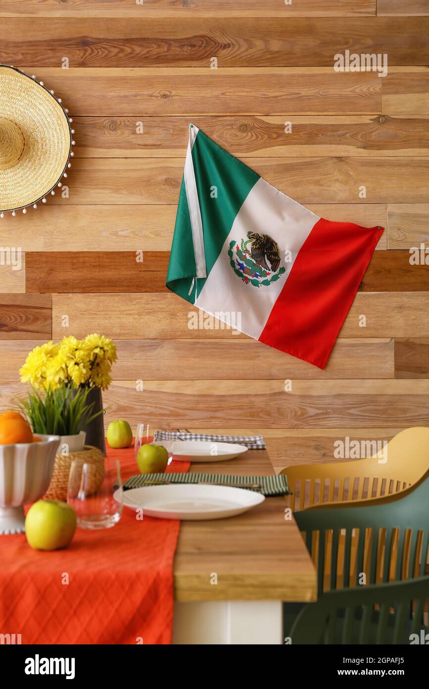 Mexican flag and dining table near wooden wall Stock Photo - Alamy