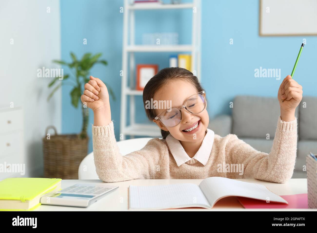 Little girl doing lessons at home Stock Photo - Alamy
