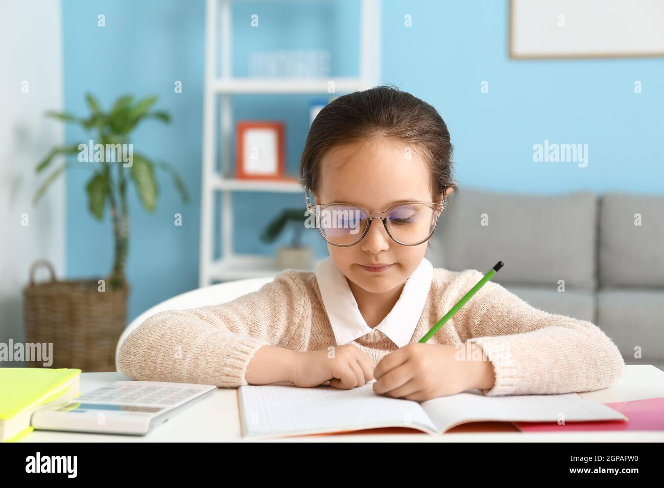 Little girl doing lessons at home Stock Photo - Alamy
