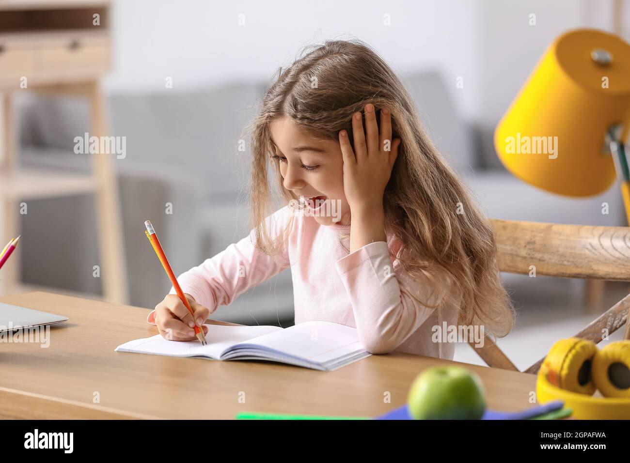 Little girl doing lessons at home Stock Photo - Alamy