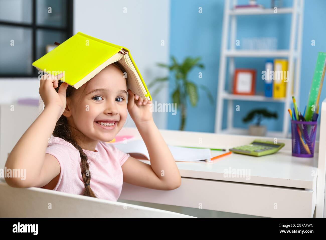 Little girl doing lessons at home Stock Photo - Alamy