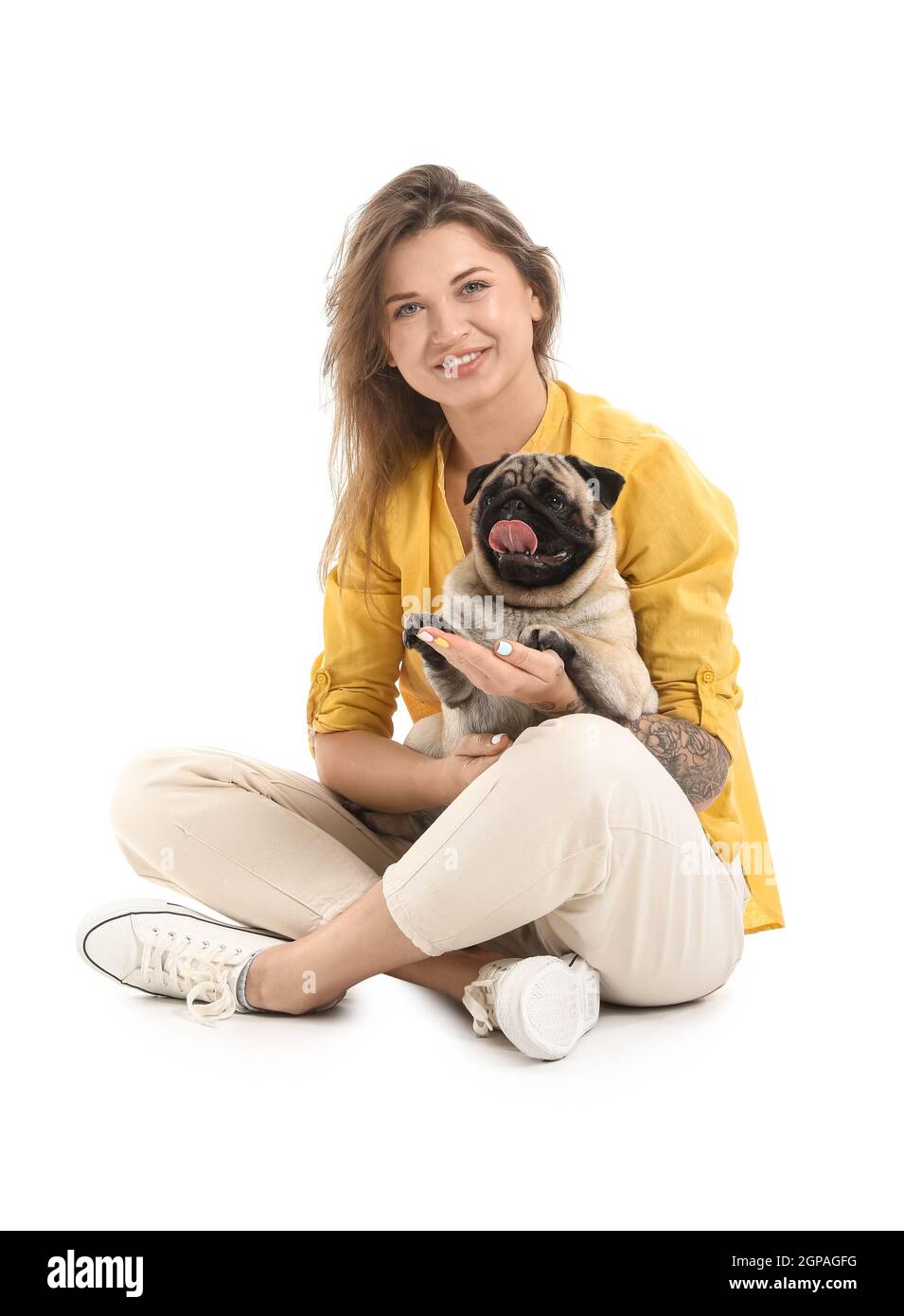 Young woman with cute pug dog on white background Stock Photo - Alamy