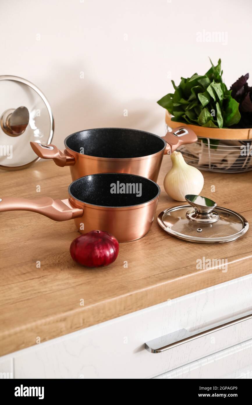 Cooking pots with onion on kitchen counter Stock Photo - Alamy