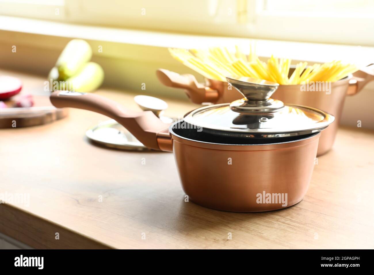 Copper cooking pot on counter in kitchen, closeup Stock Photo - Alamy
