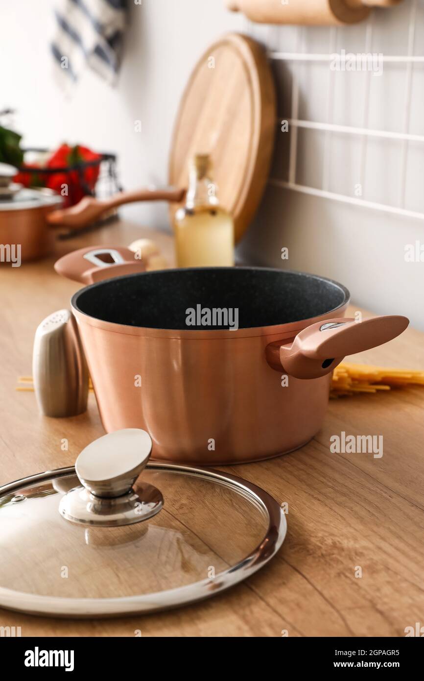 Copper cooking pot on counter in kitchen Stock Photo - Alamy