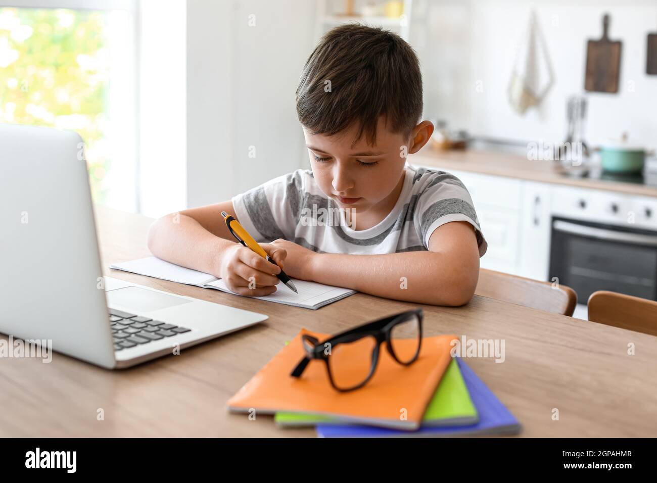 Little boy doing homework in room Stock Photo - Alamy