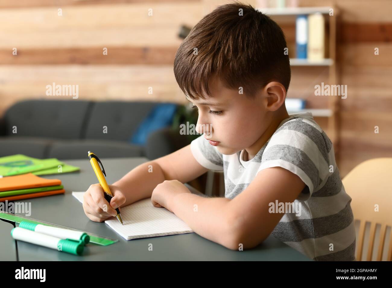 Little boy doing homework in room Stock Photo - Alamy