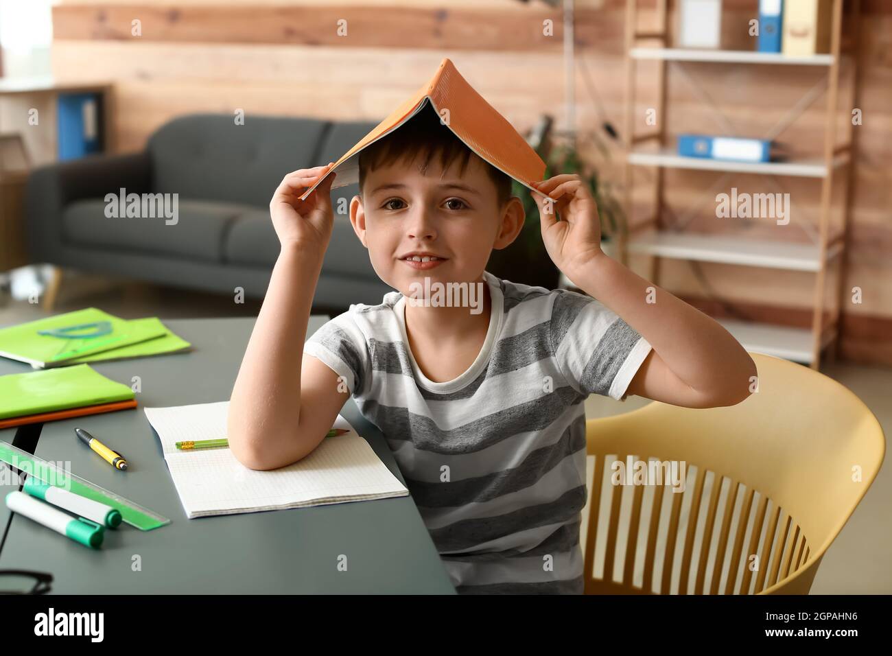Little boy doing homework in room Stock Photo - Alamy