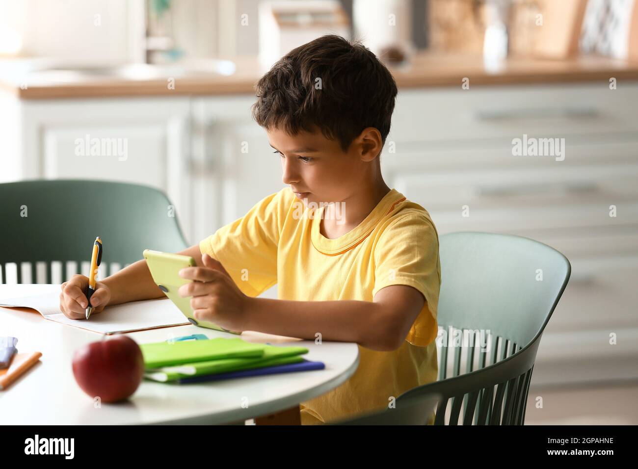 Little boy doing homework in room Stock Photo - Alamy