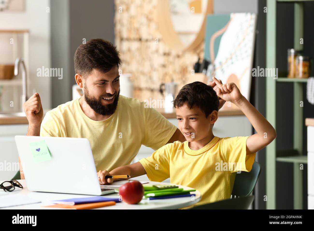 Little boy with his father doing lessons online at home Stock Photo - Alamy