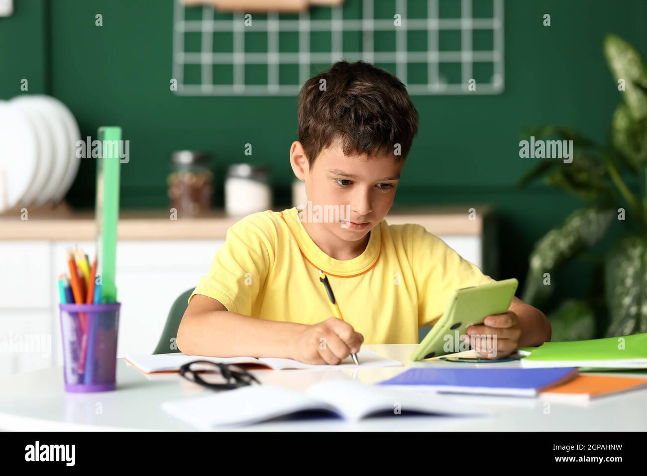 Little boy doing homework in room Stock Photo - Alamy