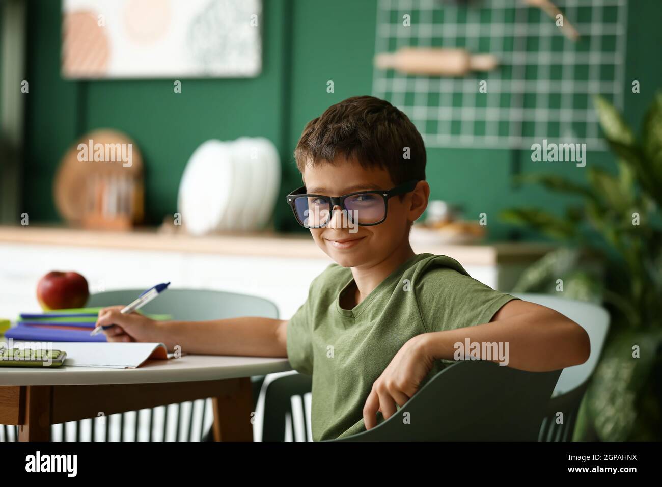 Little boy doing lessons at home Stock Photo - Alamy