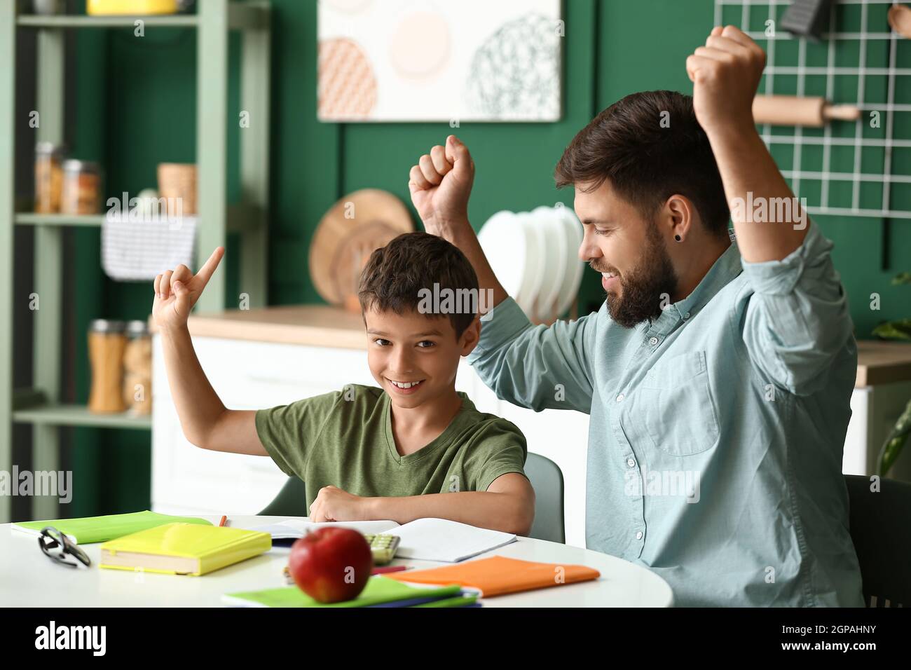 Little boy with his father doing lessons at home Stock Photo - Alamy