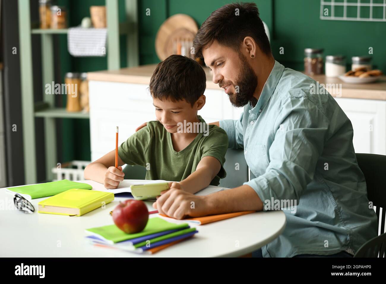 Little boy with his father doing lessons at home Stock Photo - Alamy