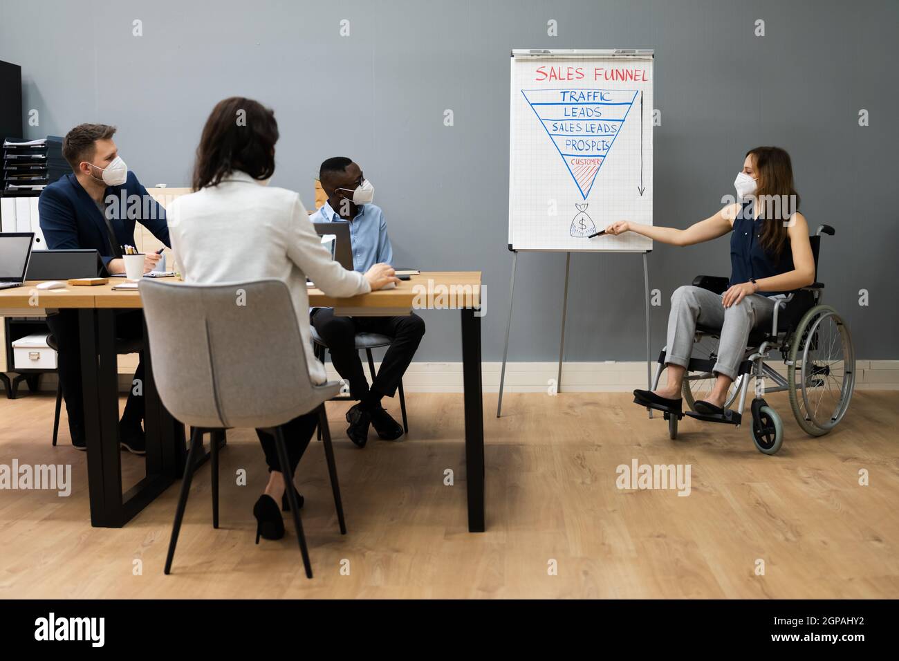 Disabled Person Giving Presentation To Diverse Group In Face Mask Stock ...