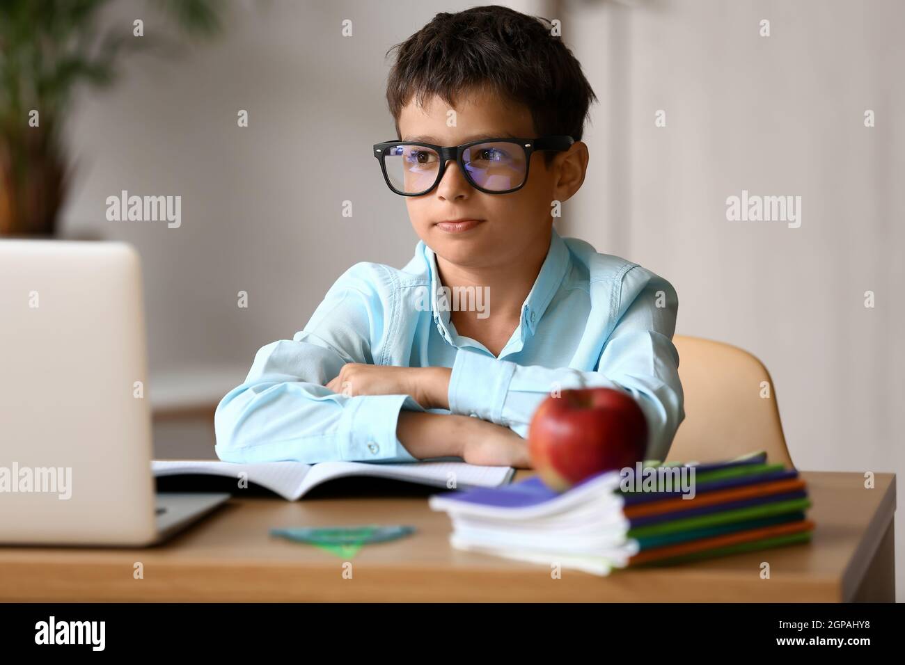 Little boy doing lessons at home Stock Photo - Alamy