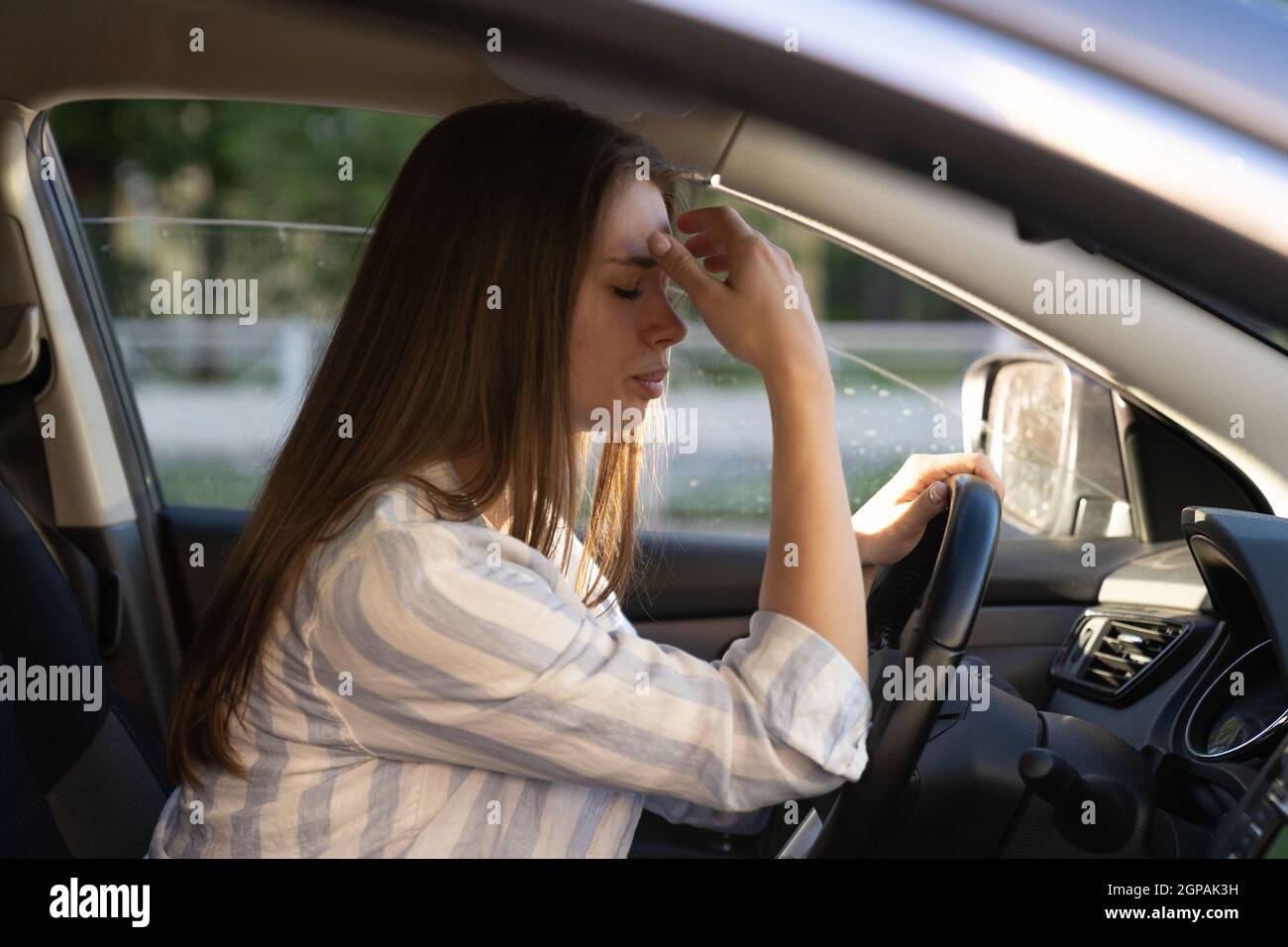 Sad tired young woman driving car. Unhappy girl driver depressed and ...