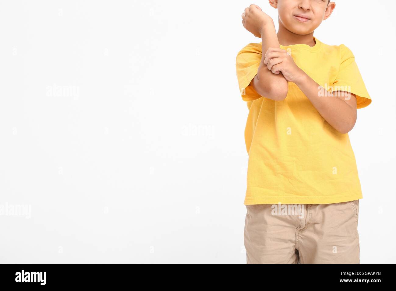 Little boy scratching himself on white background Stock Photo - Alamy